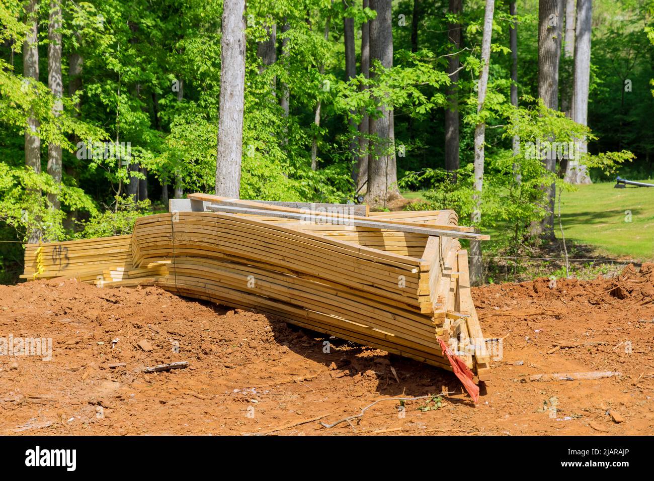 Stacked wooden timber for trusses for roof near construction site Stock ...