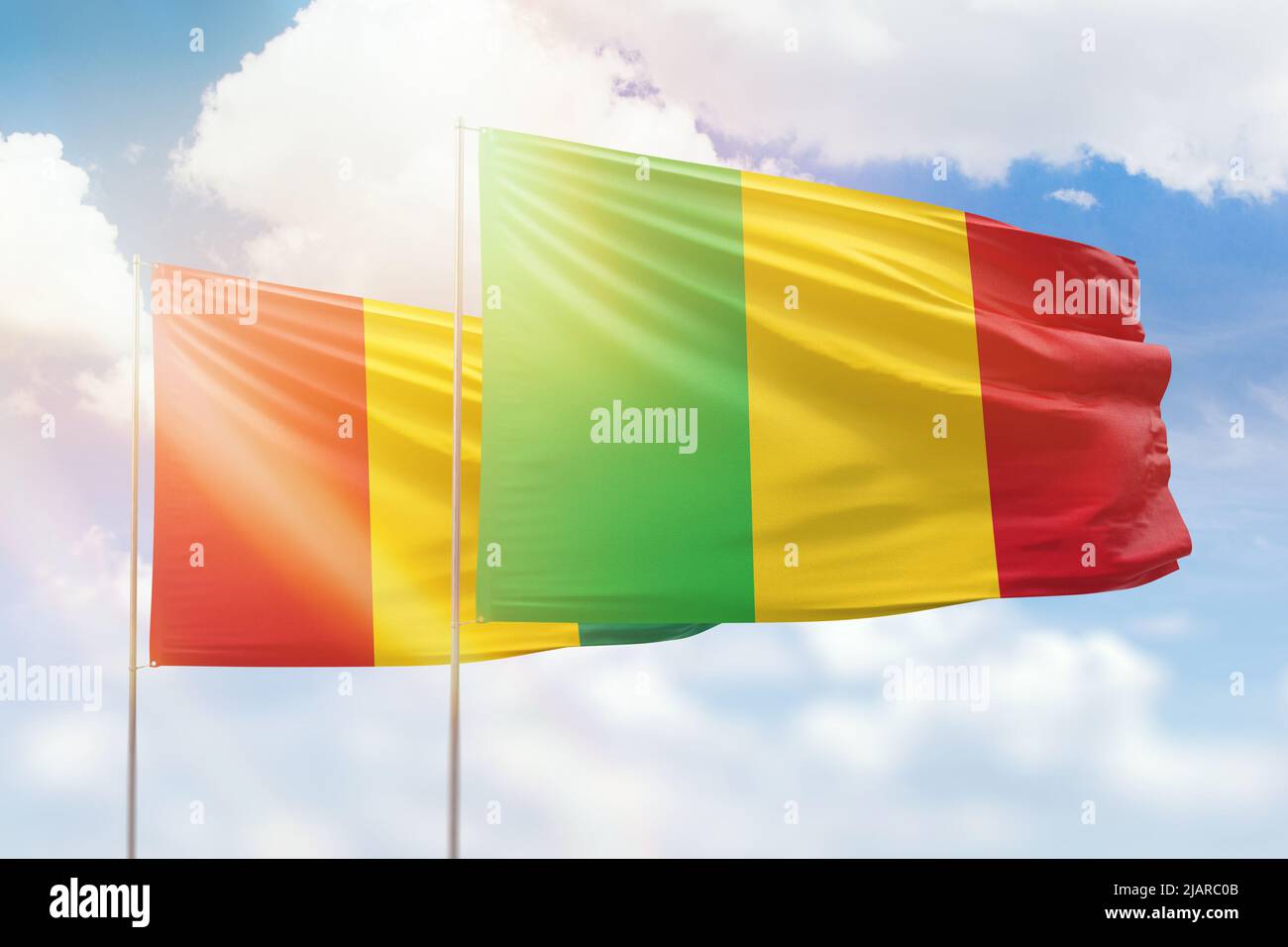 Sunny blue sky and flags of mali and guinea Stock Photo - Alamy