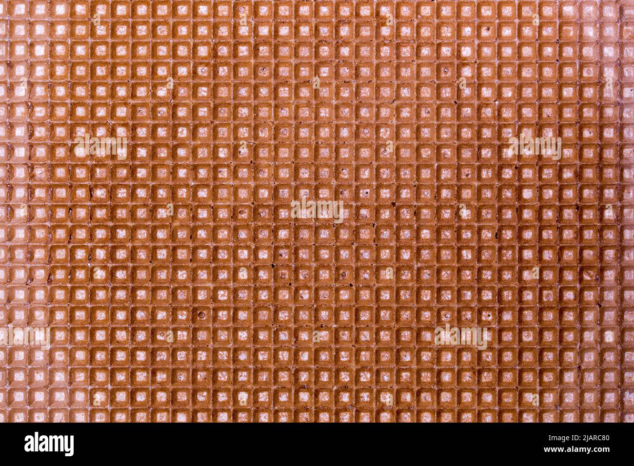 Background and texture of a surface of a confectionery waffle of brown ...