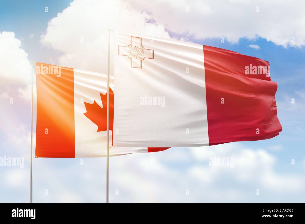 Sunny blue sky and flags of malta and canada Stock Photo - Alamy