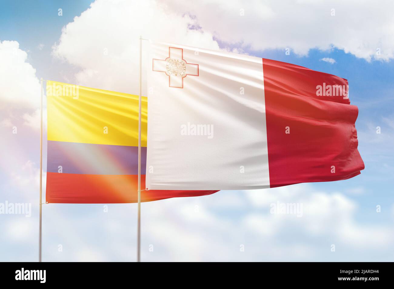 Sunny blue sky and flags of malta and colombia Stock Photo - Alamy