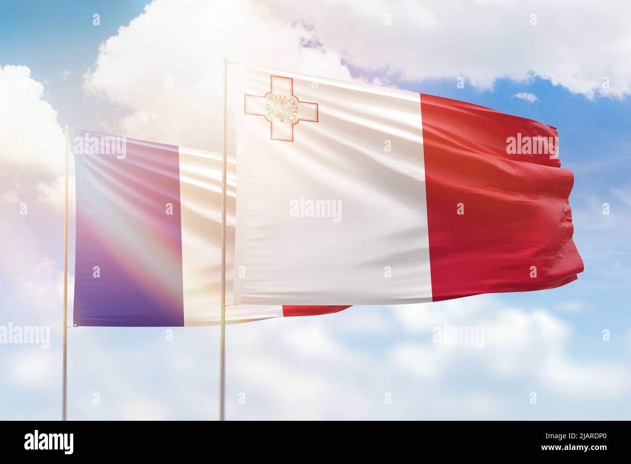 Sunny blue sky and flags of malta and france Stock Photo - Alamy