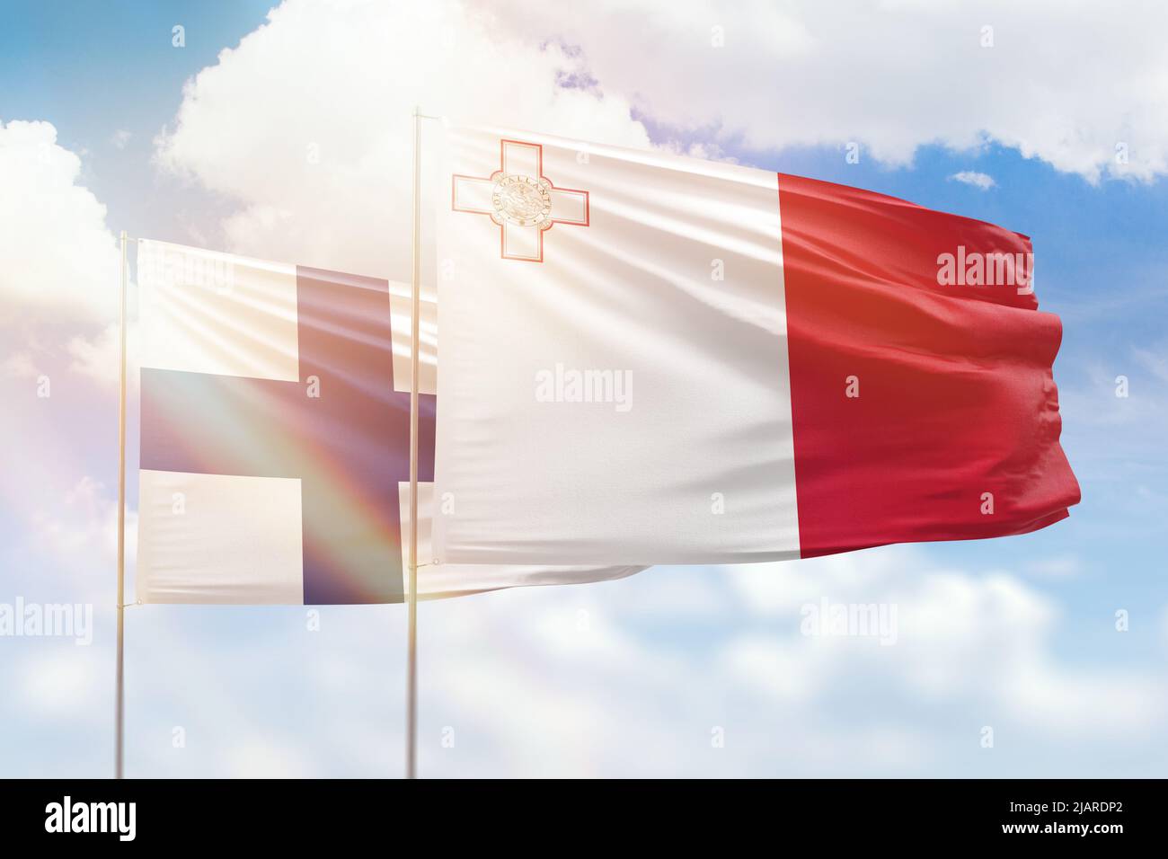 Sunny blue sky and flags of malta and finland Stock Photo - Alamy