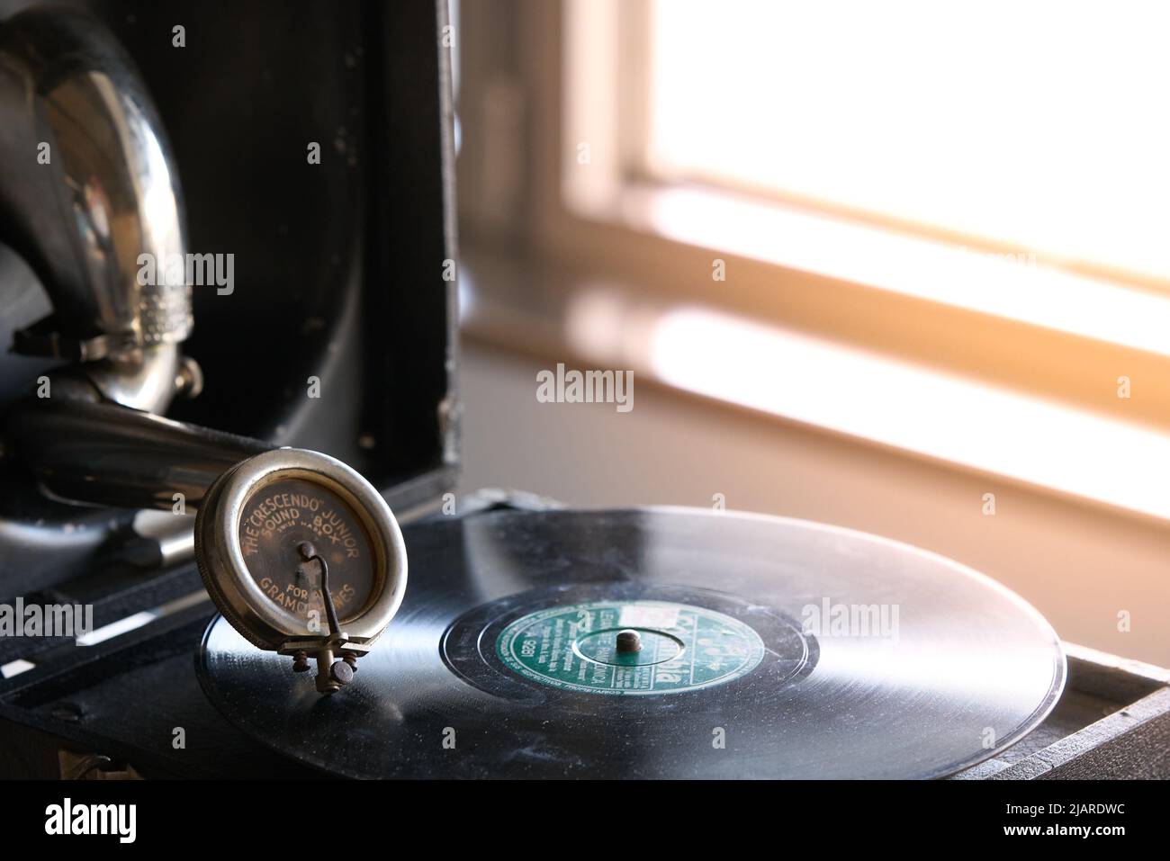 antique portable gramophone with a powder covered vinyl record Stock ...