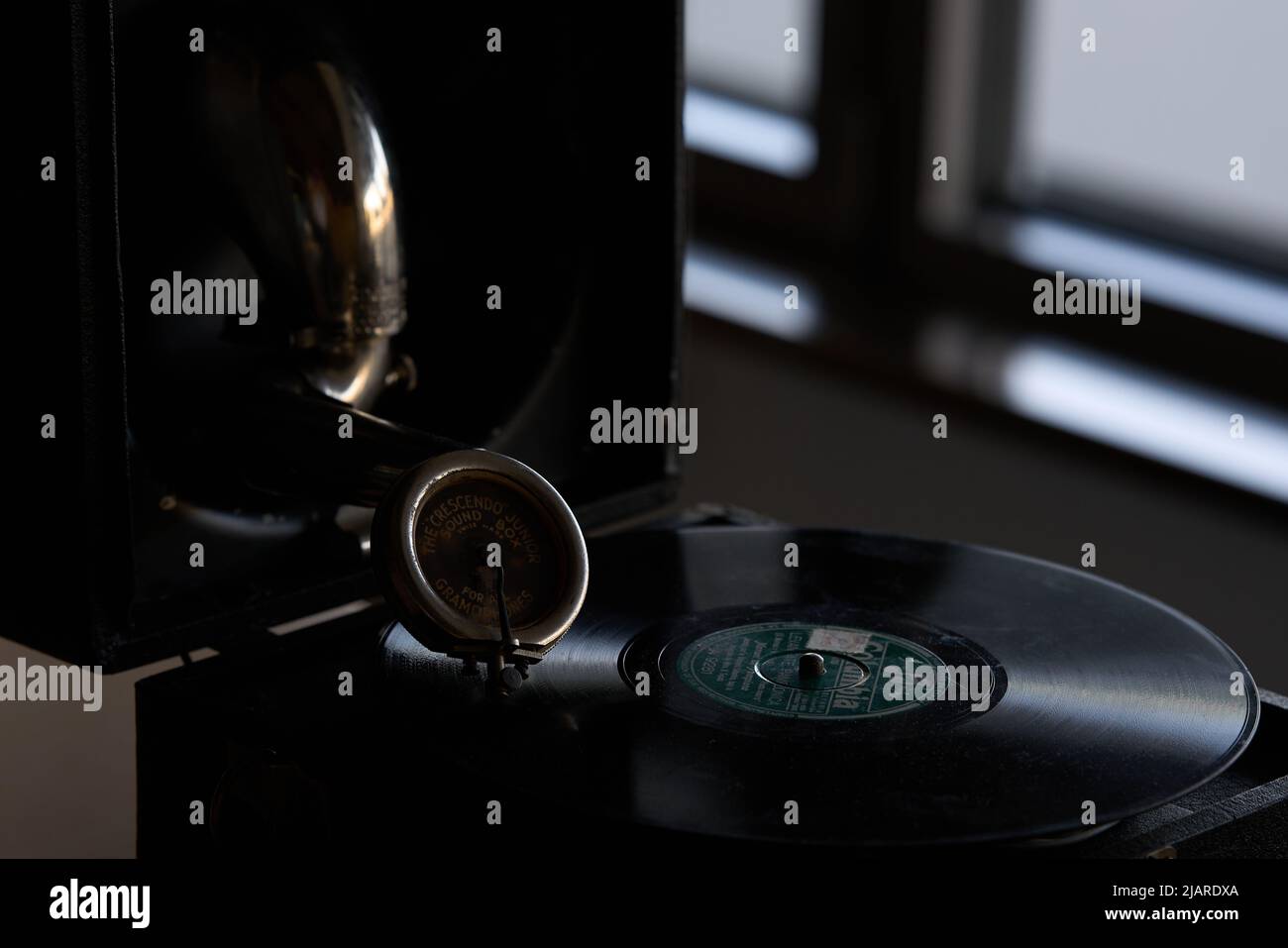 antique portable gramophone with a powder covered vinyl record Stock ...