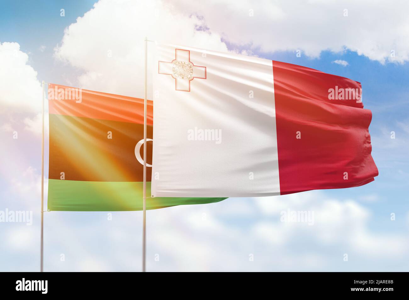 Sunny blue sky and flags of malta and libya Stock Photo - Alamy