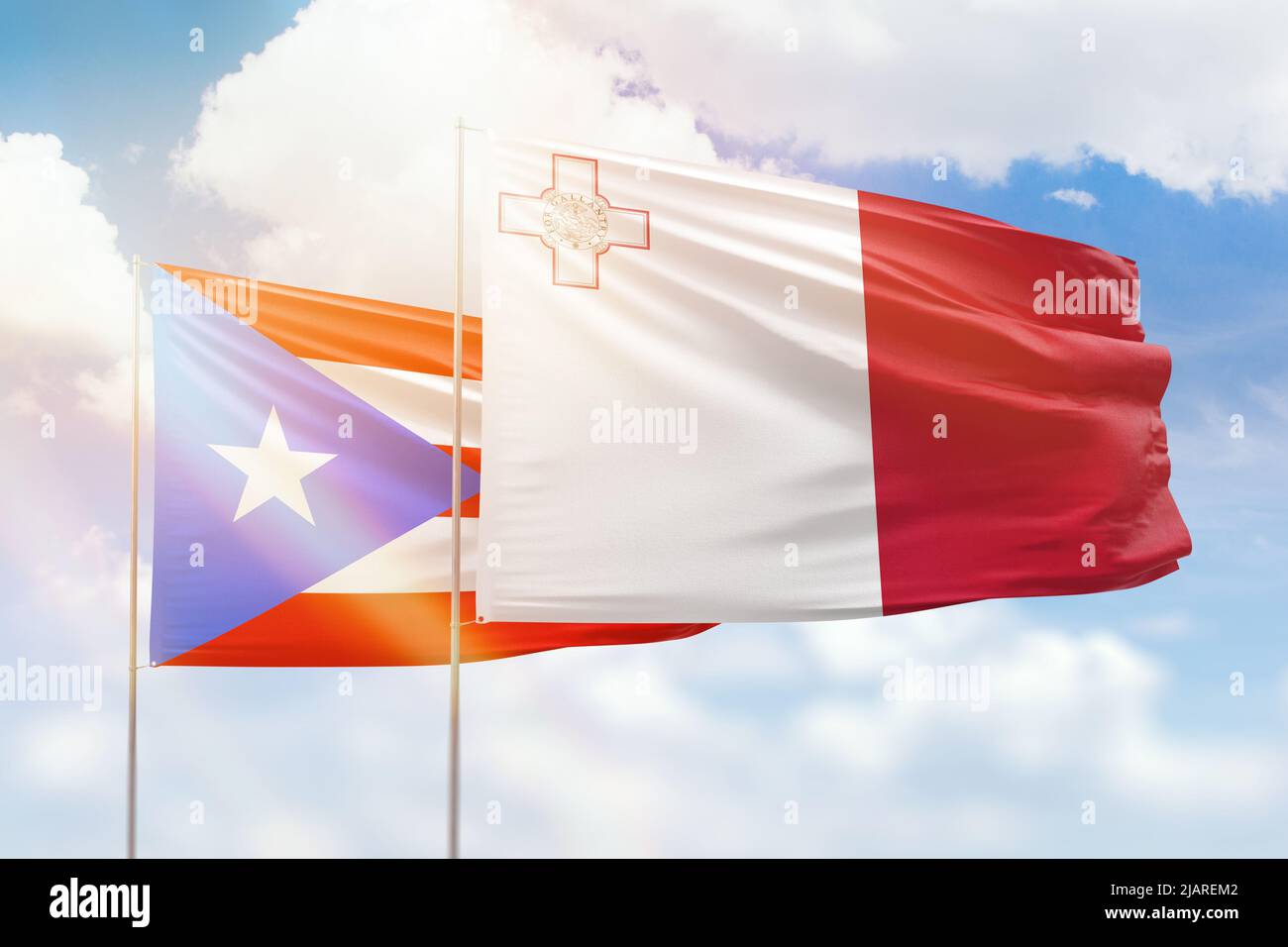 Sunny blue sky and flags of malta and puerto rico Stock Photo - Alamy