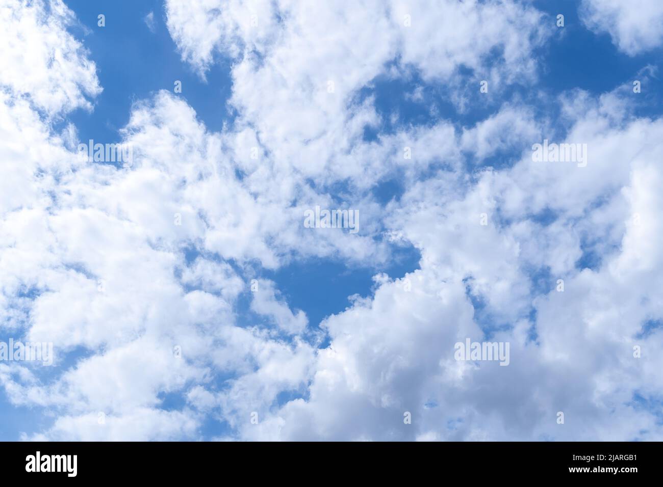 Blue sky background with white fluffy clouds. Clear weather, a feeling ...