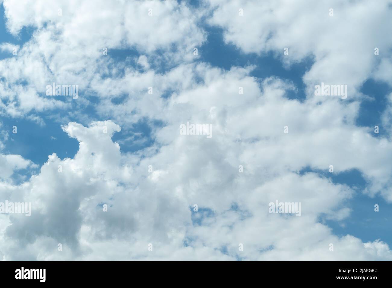 Blue sky background with white fluffy clouds. Clear weather, a feeling ...