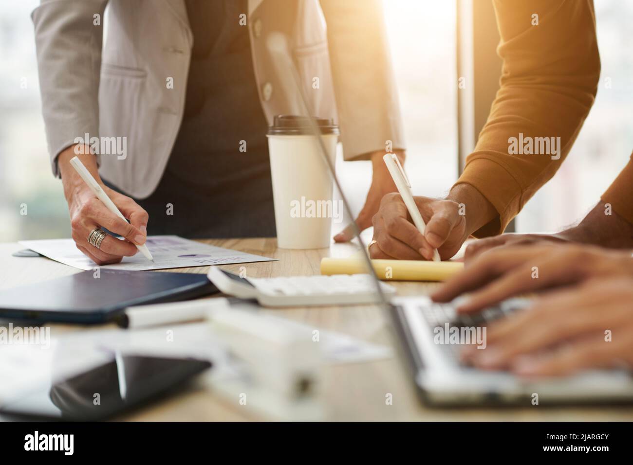 Business people taking notes while having brainstorming session in ...