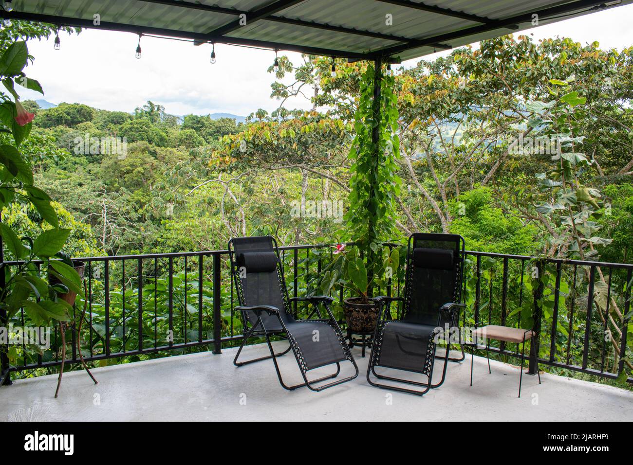Balcony in the forest with two black chairs in Costa Rica Stock Photo ...