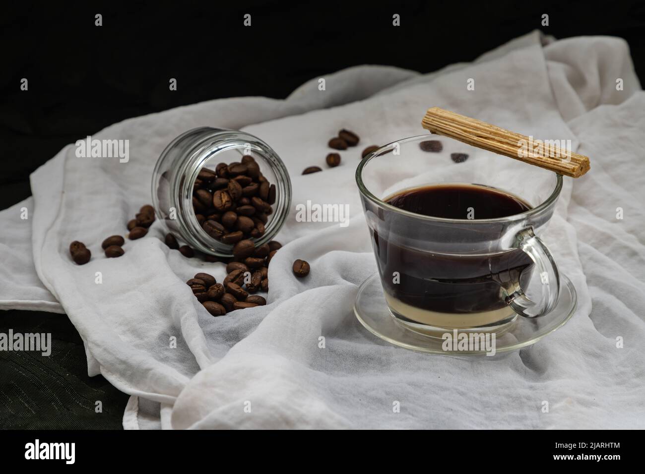 Two layers of coffee in a transparent glass with Espresso coffee and ...