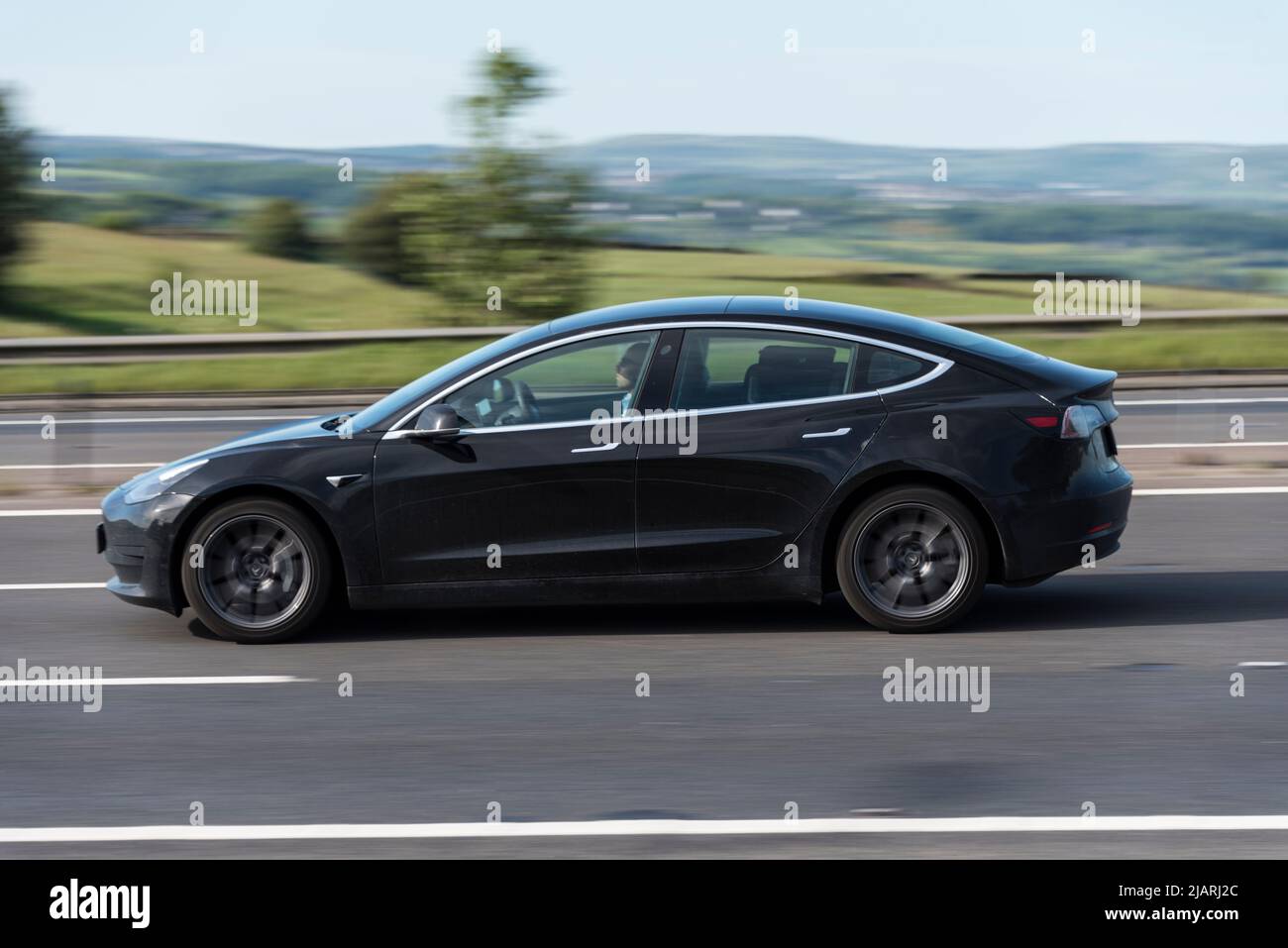Electric Car (Tesla) on the M62 (near Huddersfield, England Stock Photo ...