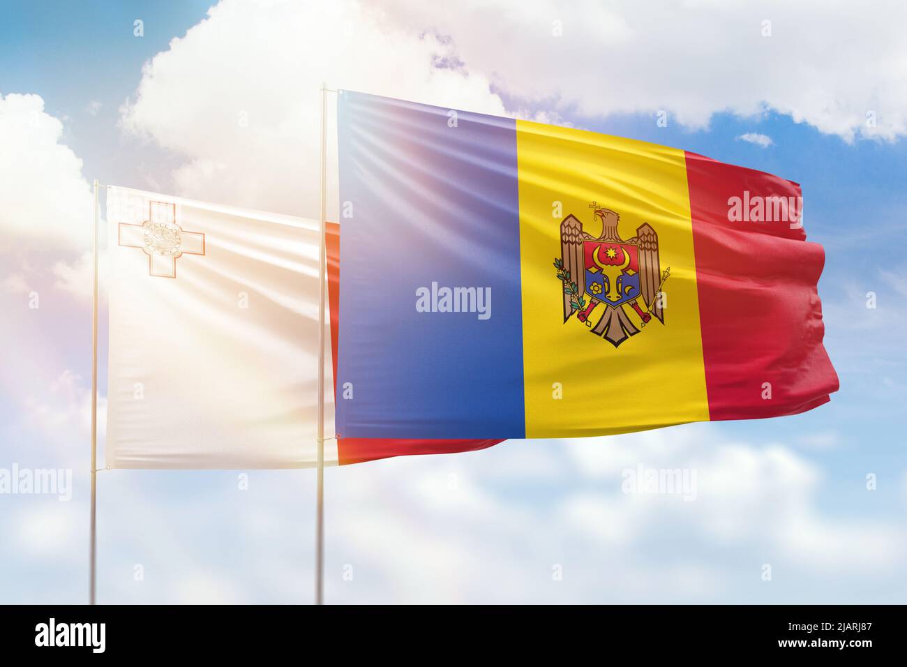 Sunny blue sky and flags of moldova and malta Stock Photo - Alamy