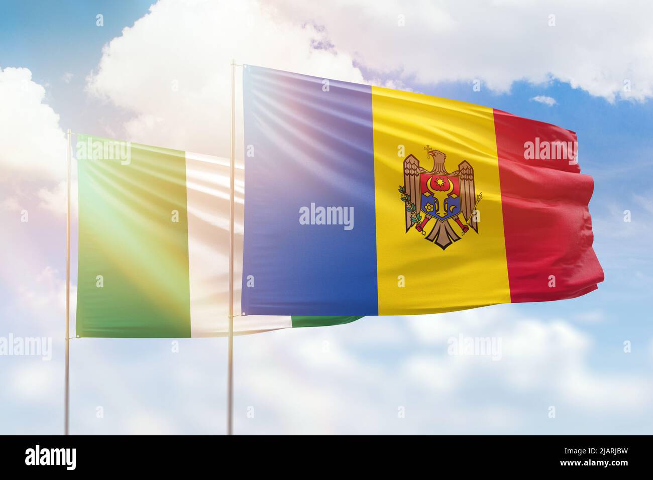 Sunny blue sky and flags of moldova and nigeria Stock Photo - Alamy