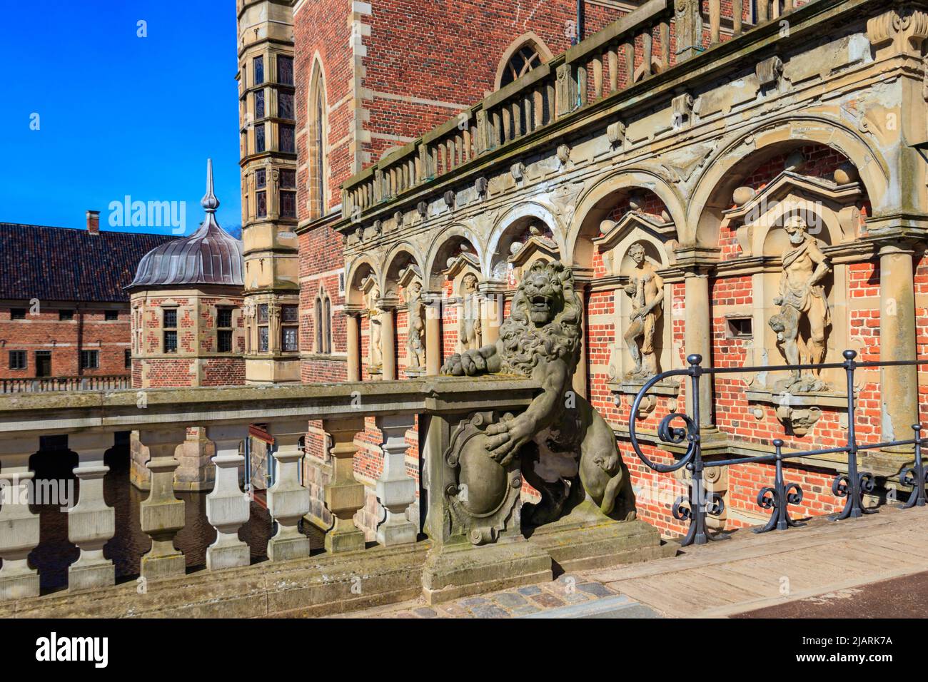 Statue of lion at the entrance to Frederiksborg castle in Hillerod ...