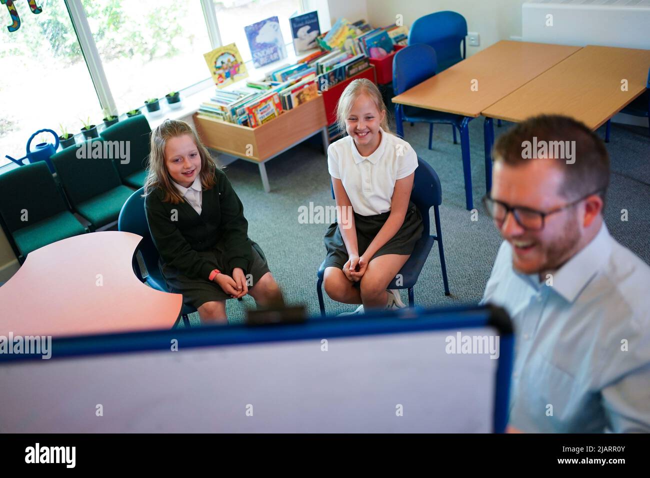 Ukrainian pupil Sofi (centre) and her classroom buddy Sylvia being taught by Tom Ormston at ...