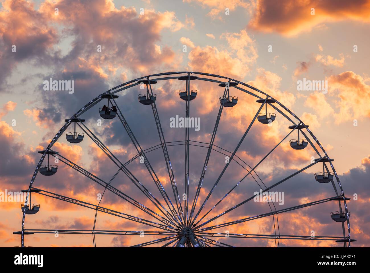 Ferris Wheel with dramatic Sky and clouds. sunset over amusement park ...