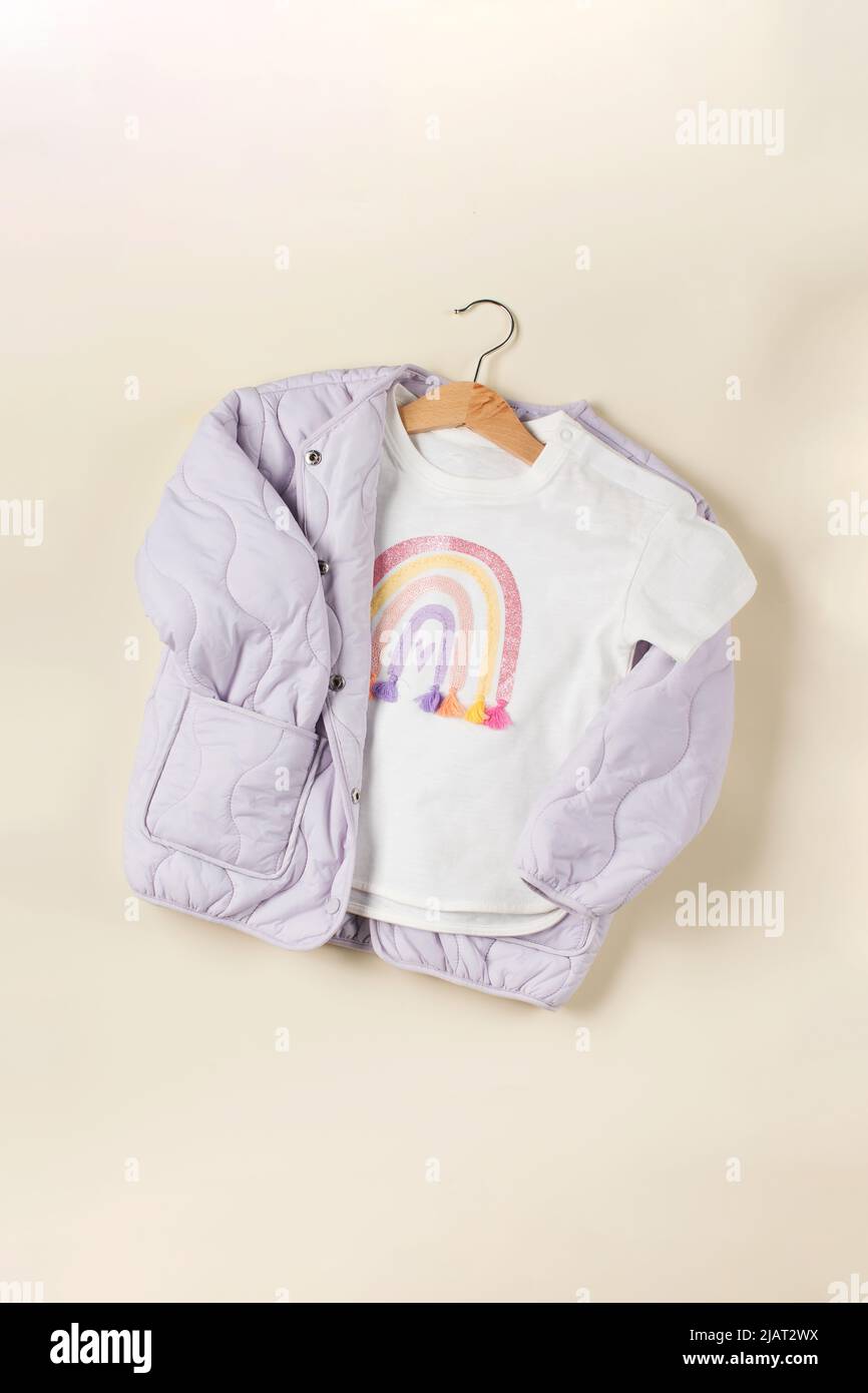 Children's lilac jacket and white T-shirt with a rainbow on a hanger on ...