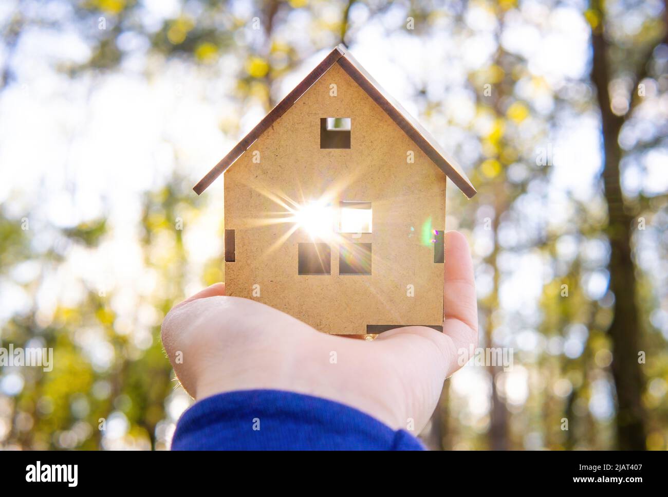 Sunlight coming through the window of a small plywood house held ...