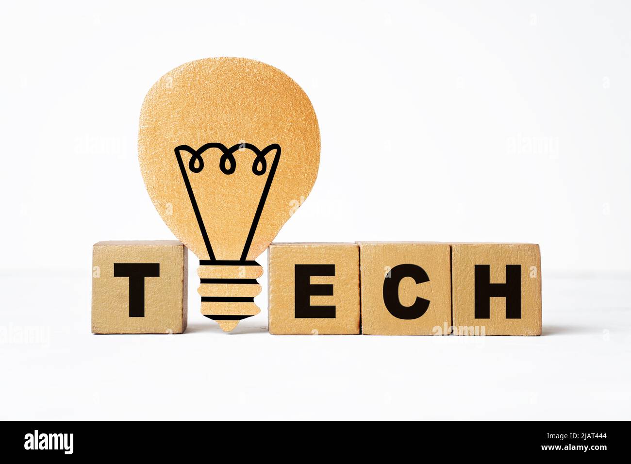 Word TECH made from wooden letter blocks and a flat lightbulb shape ...