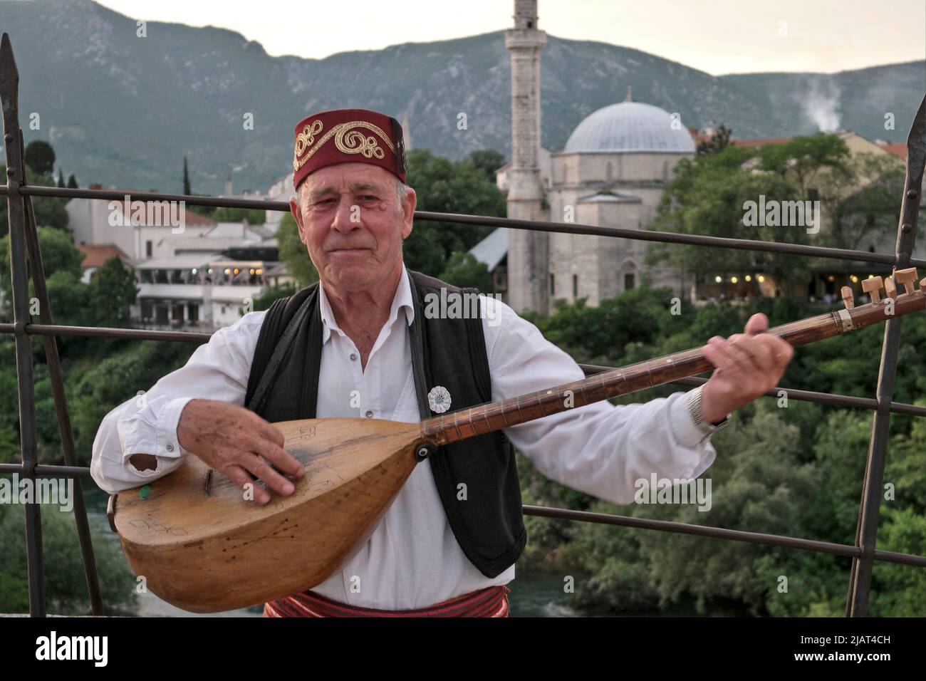 Mostar, Bosnia and Herzegovina – May 2022: Man playing gusle on top of ...