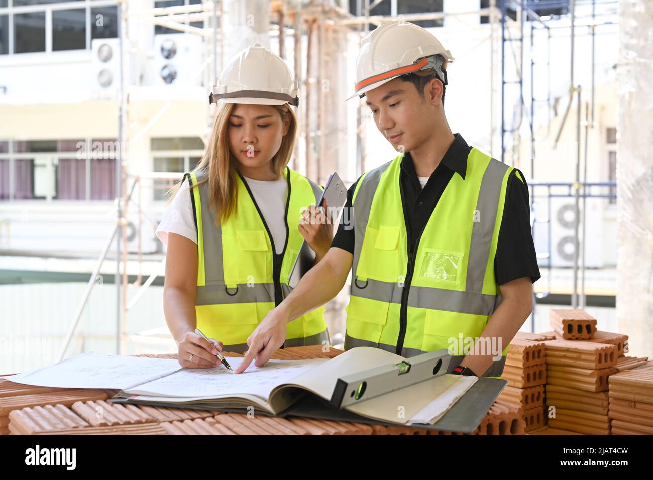 Civil engineer and specialists working, checking plan together at ...