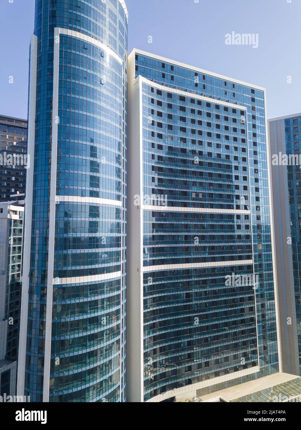 Drone view of a modern glass multi-storey building on a sunny day ...