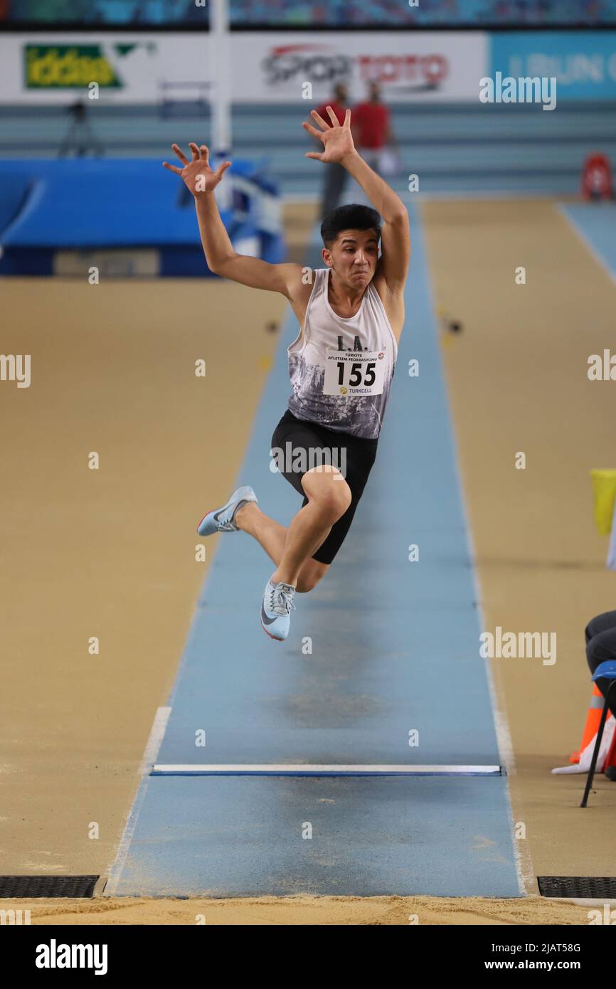 ISTANBUL, TURKEY - DECEMBER 11, 2021: Undefined athlete long jumping ...