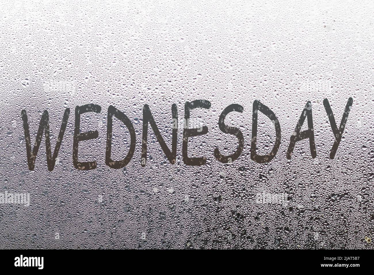 wednesday written on the glass screen with raindrops background Stock ...