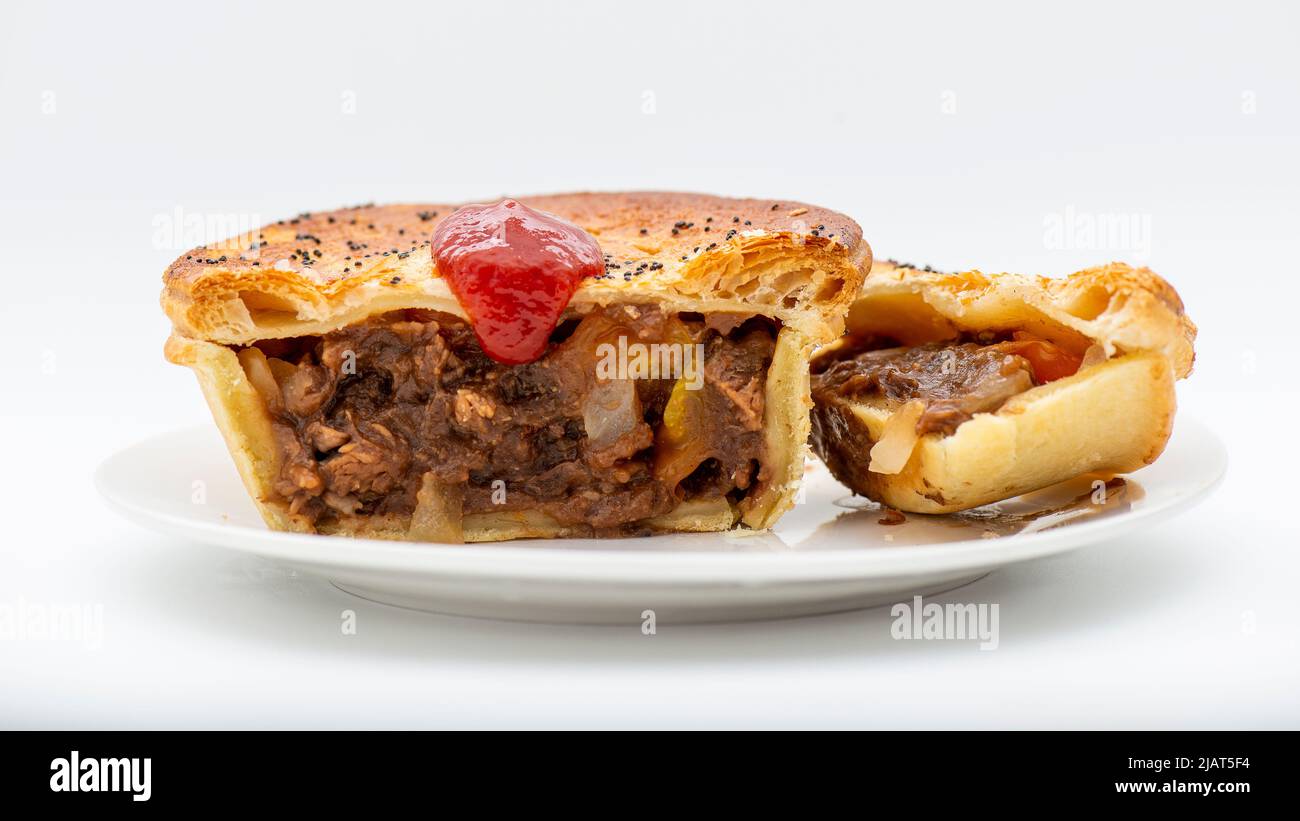 Fresh baked golden flaky chunky tomato and onion flavoured pie Stock ...