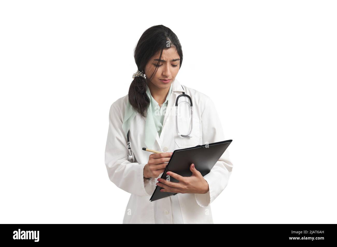 Young Venezuelan female doctor writing a medical report, isolated Stock ...