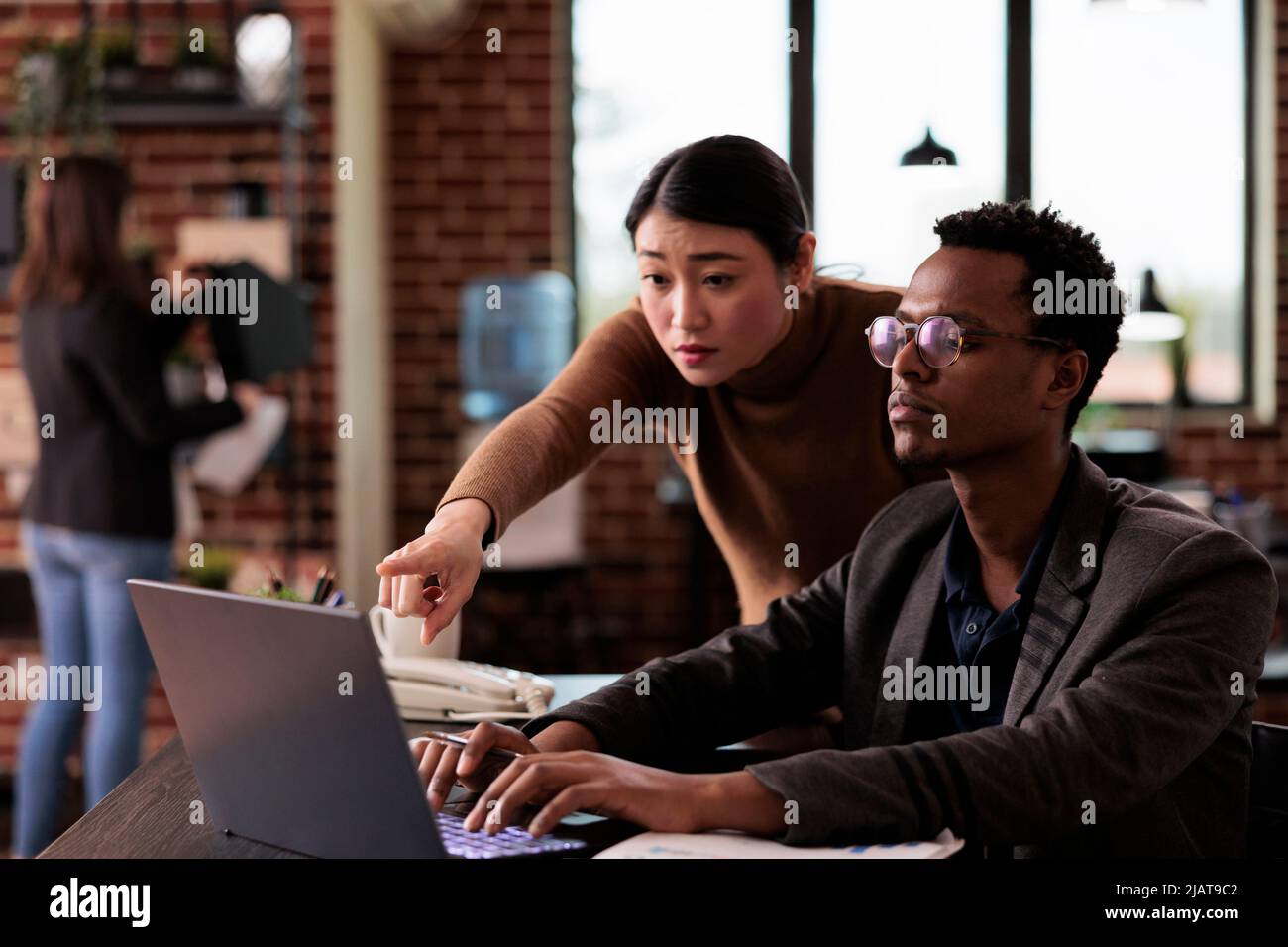 African american male employee working with asian woman on business ...