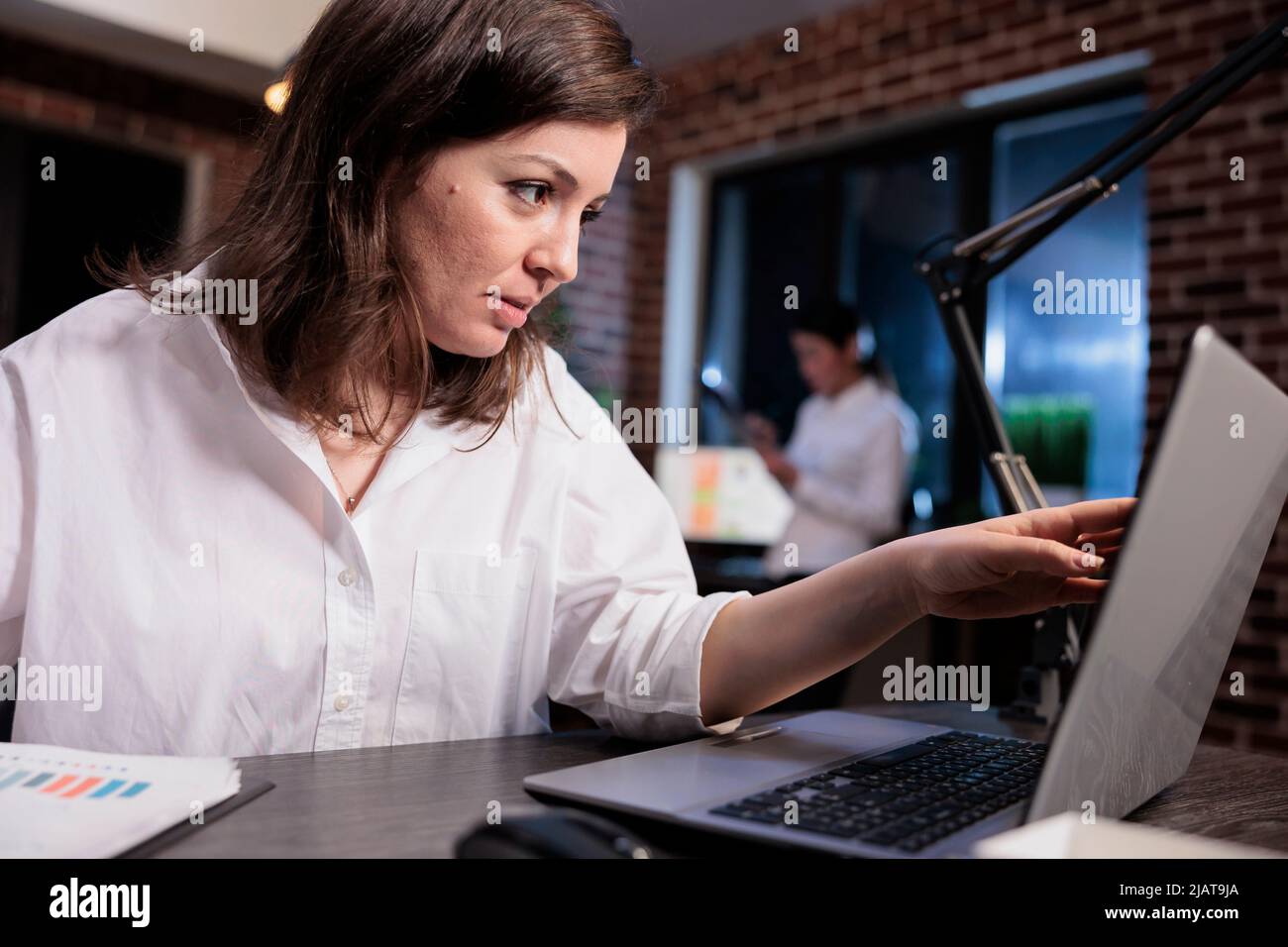 Management department leader sitting at desk in office workspace while ...