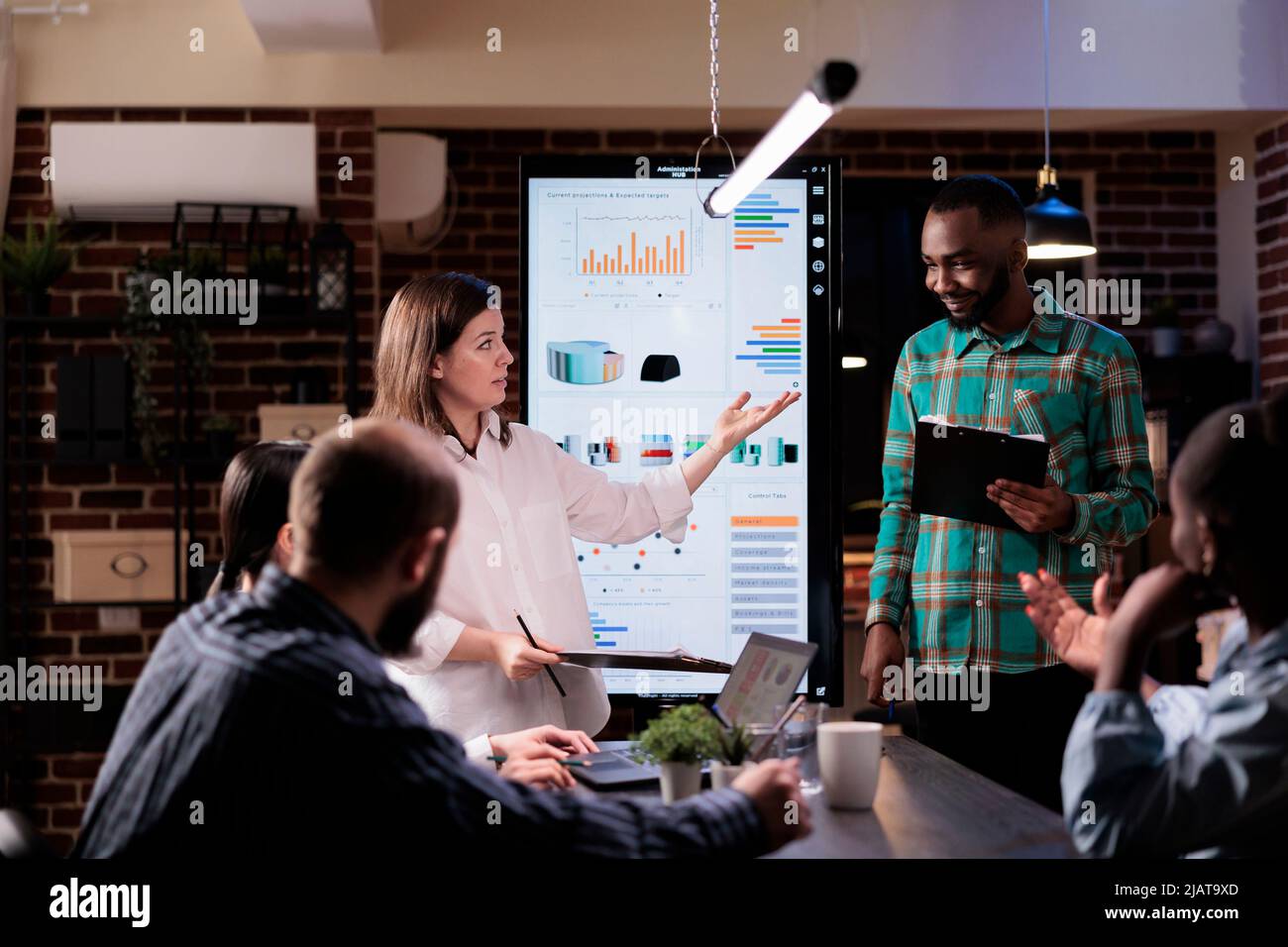 Caucasian manager presenting new african american new colleague holding ...