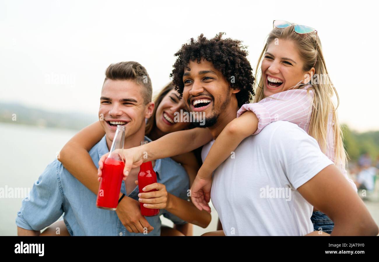 Friends having fun together at the beach and drinking a cold beer Stock ...