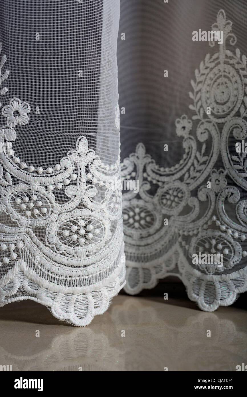 Beautiful tulle or transparent curtain with a pattern on a dark ...
