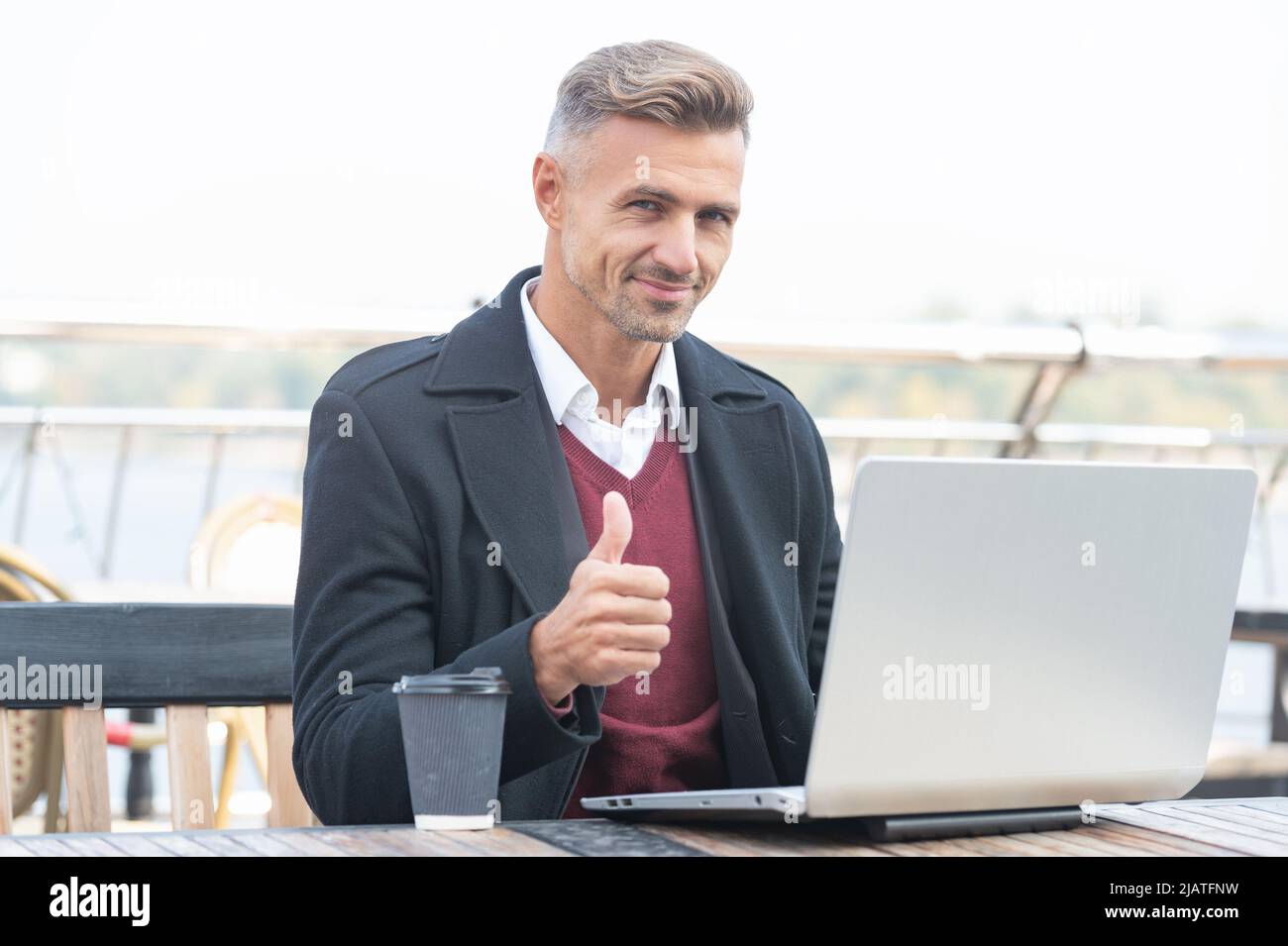 Happy professional man give thumb making approval gesture working in ...