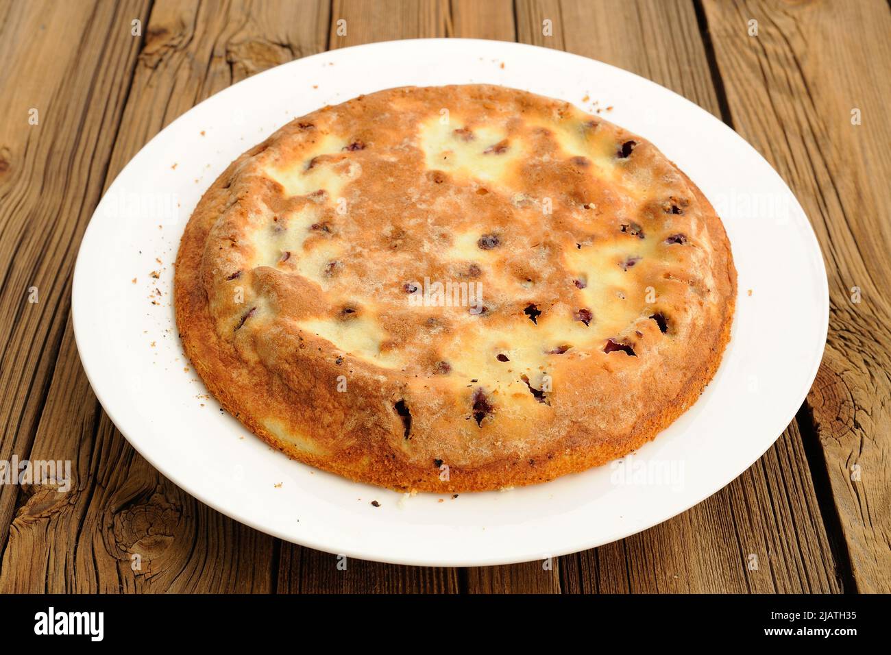 Freshly made yummy clafoutis pie with cherries on white plate ...
