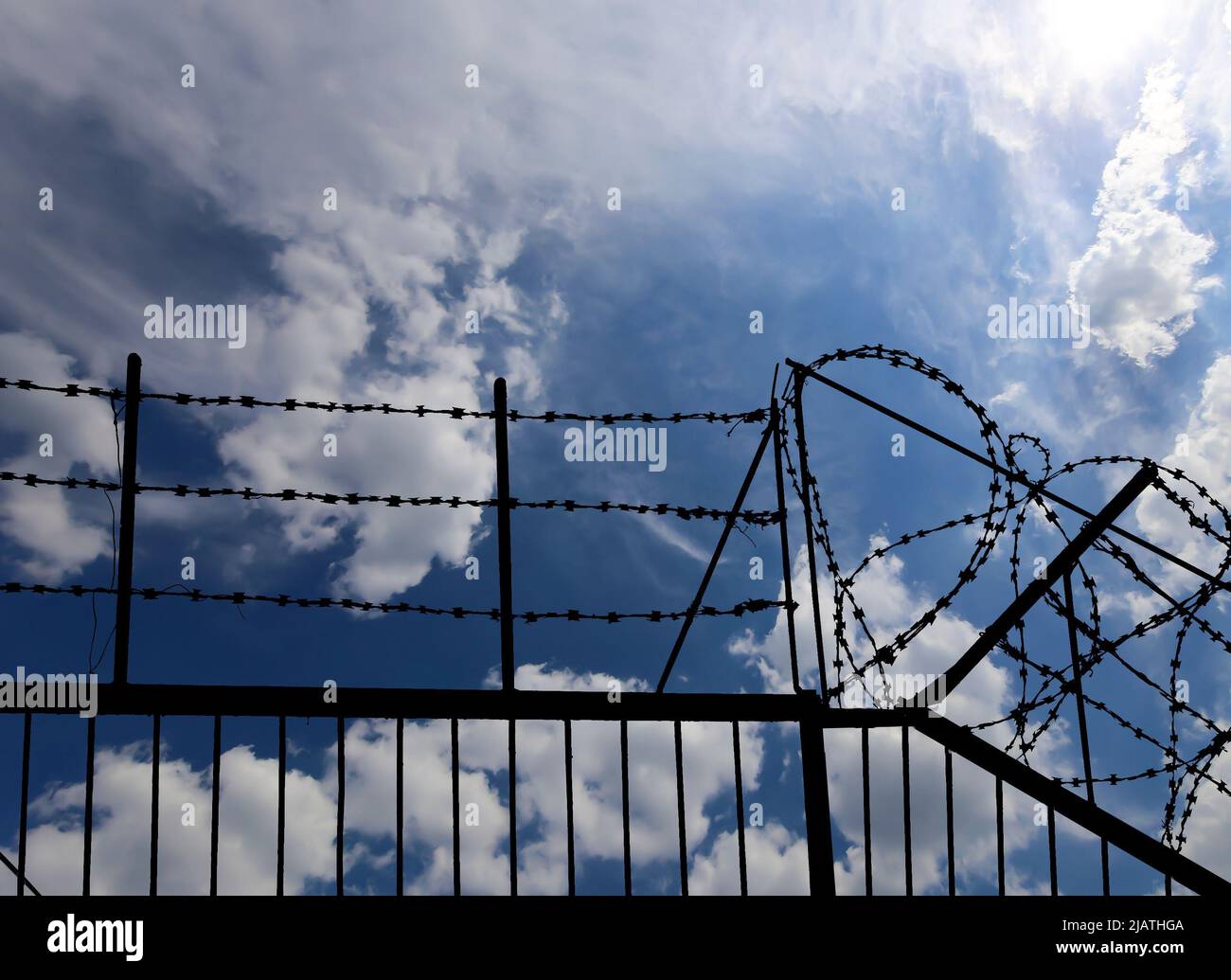 Сontour of barbed wire on background beautiful clouds and sky Stock ...