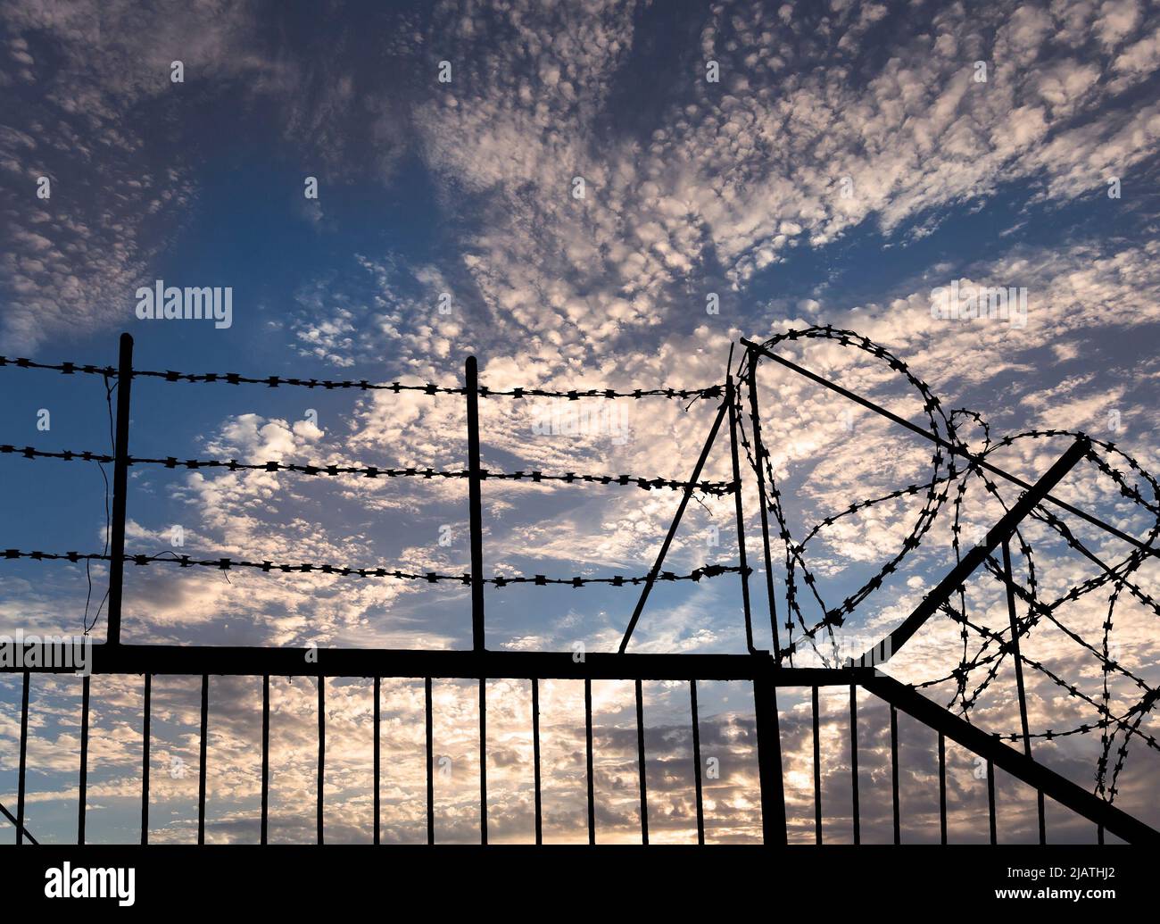 Сontour of barbed wire on background beautiful clouds and sky Stock ...
