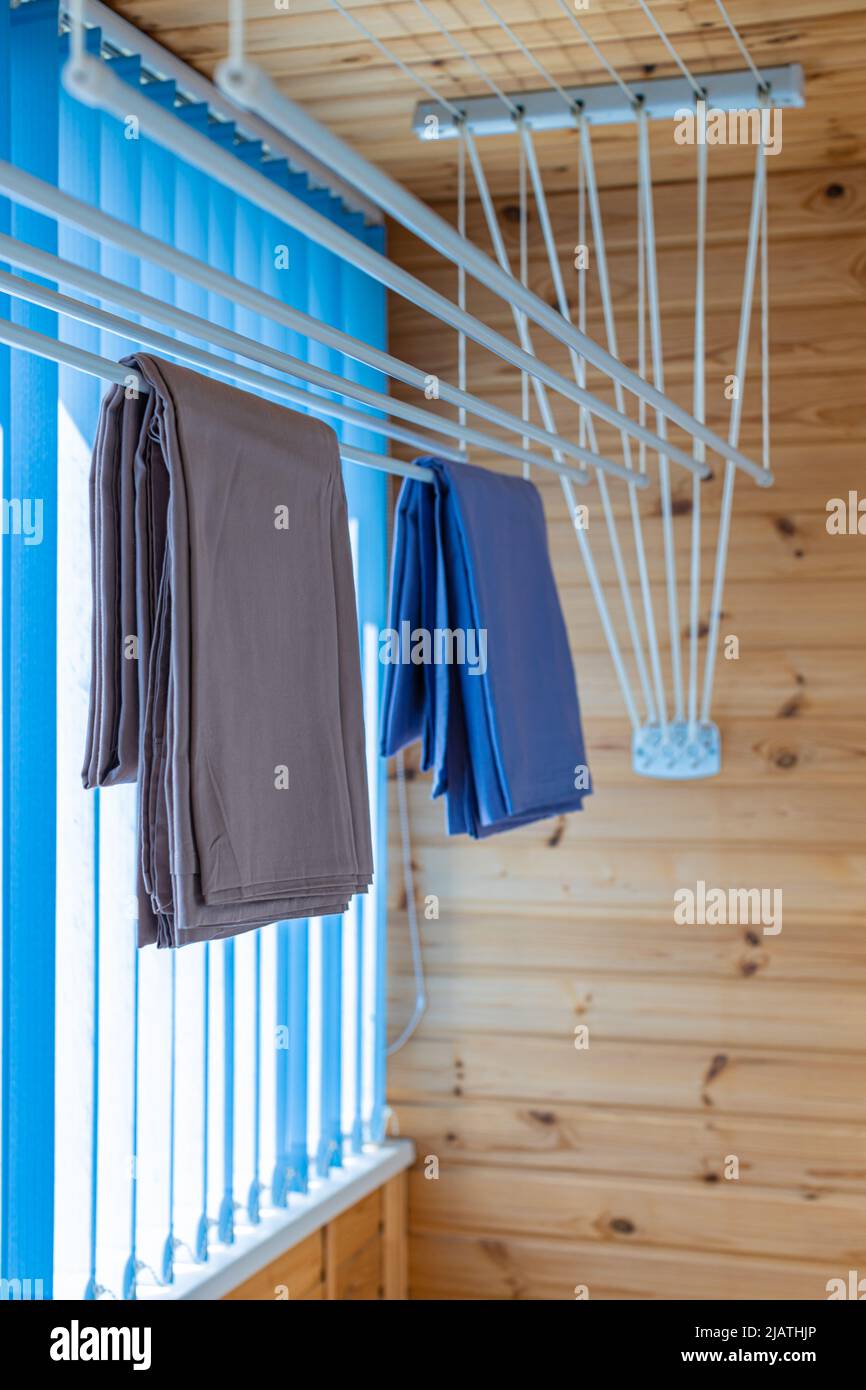 clothes dryer attached to the ceiling with clothes hanging. High ...