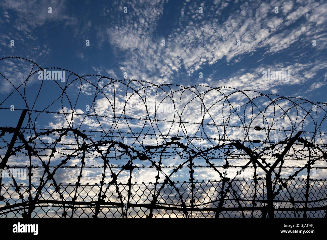 Сontour of barbed wire on background beautiful clouds and sky Stock ...