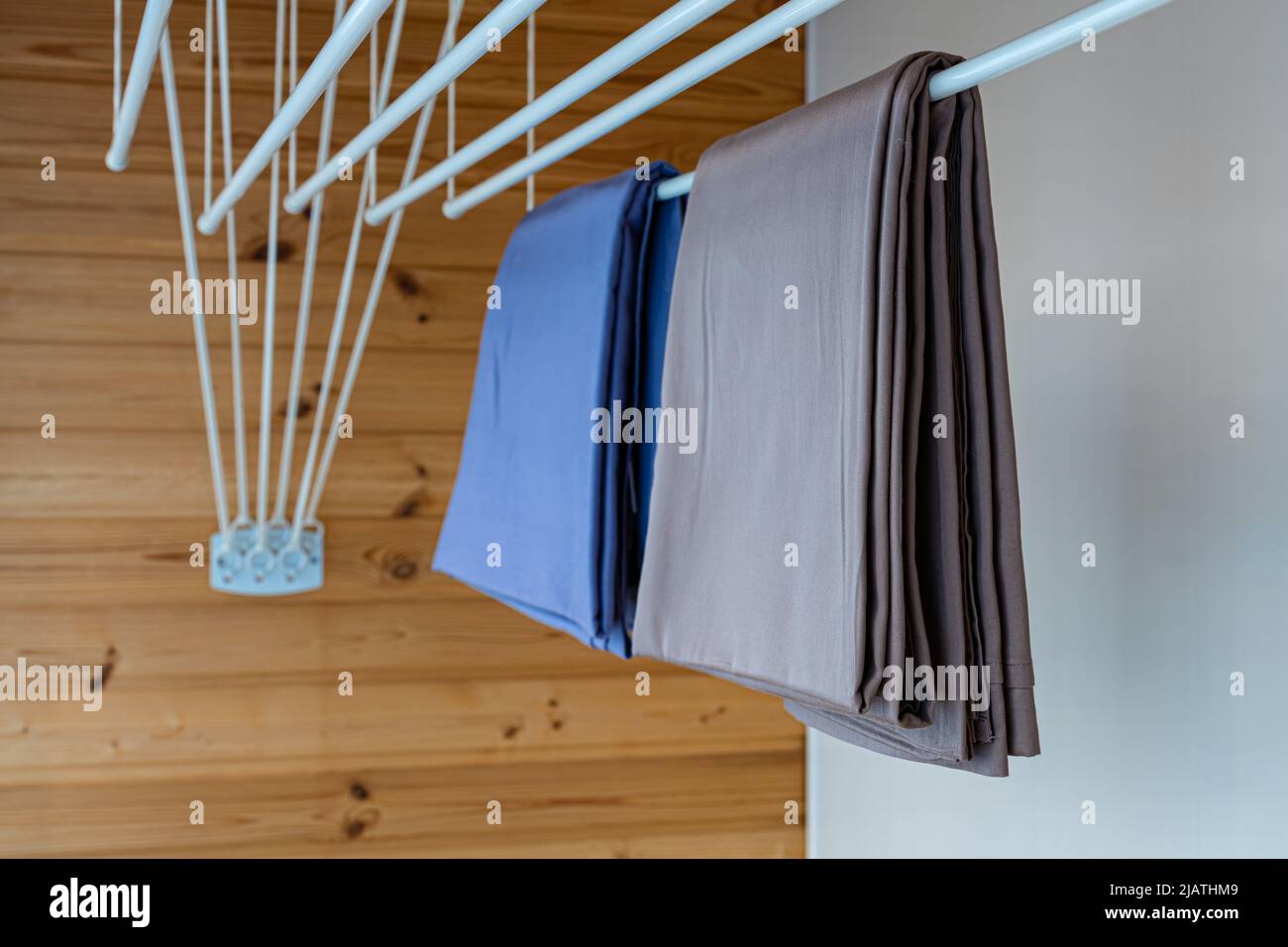 clothes dryer attached to the ceiling with clothes hanging. High ...