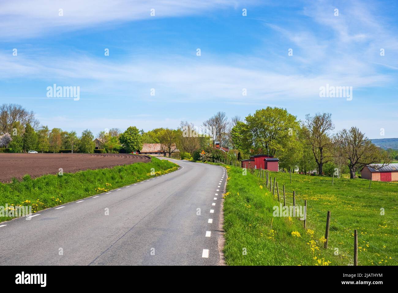 Country road in a rural landscape Stock Photo - Alamy