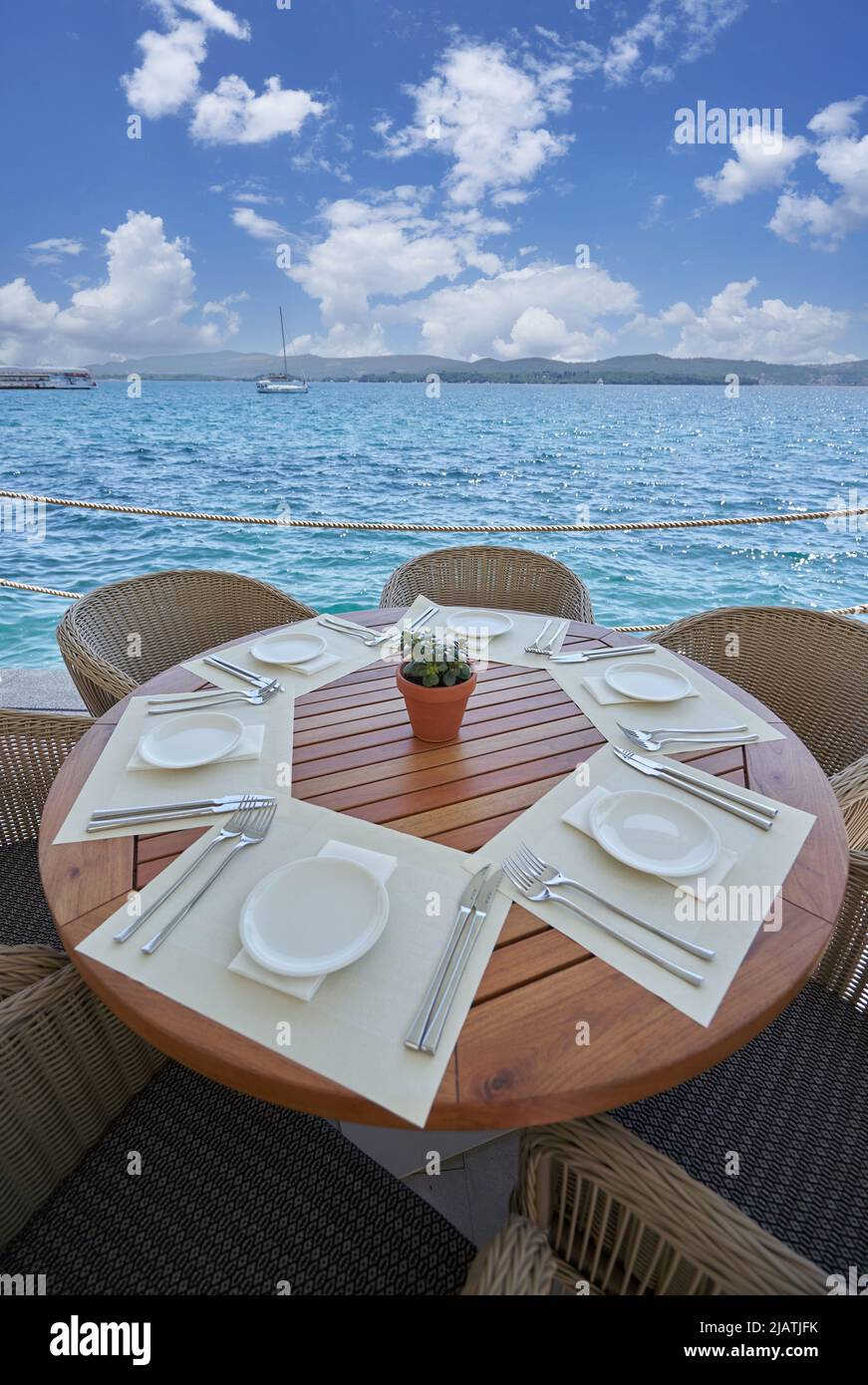 Empty round table made of wood in a restaurant with a sea view Stock ...