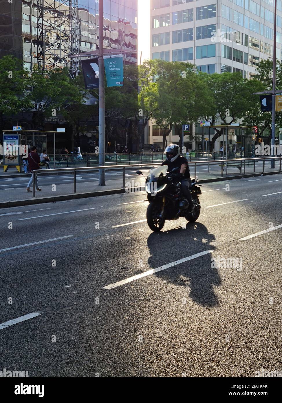 Biker running on a motorcycle on the asphalt of an avenue Stock Photo ...