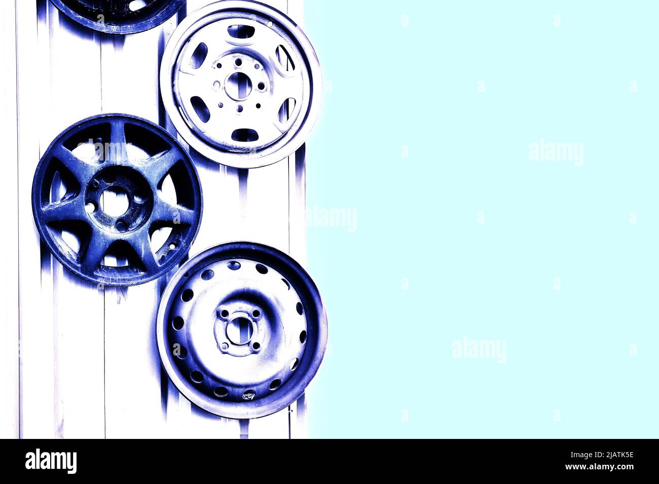 Three metal car rims hanging on the wall with space for text Stock ...