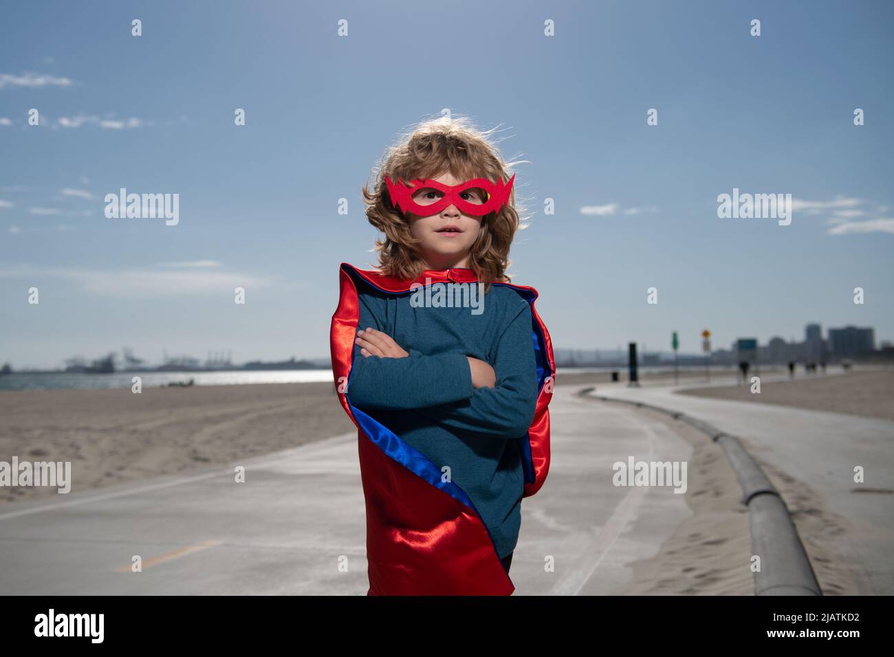 Happy child wearing a superhero costume. Super hero child against blue ...