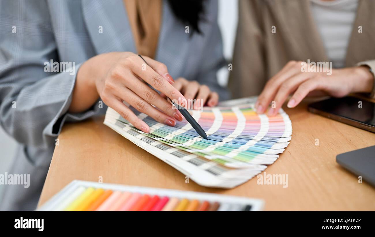 Cropped shot, Two female graphic designers are discussing and reviewing ...